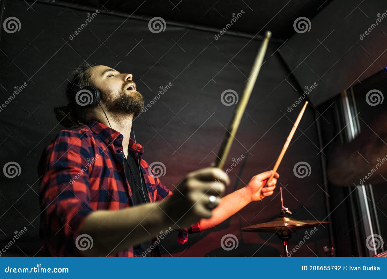 Hipster Guy with the Beard in Headphones is Playing Drum and Sining in ...