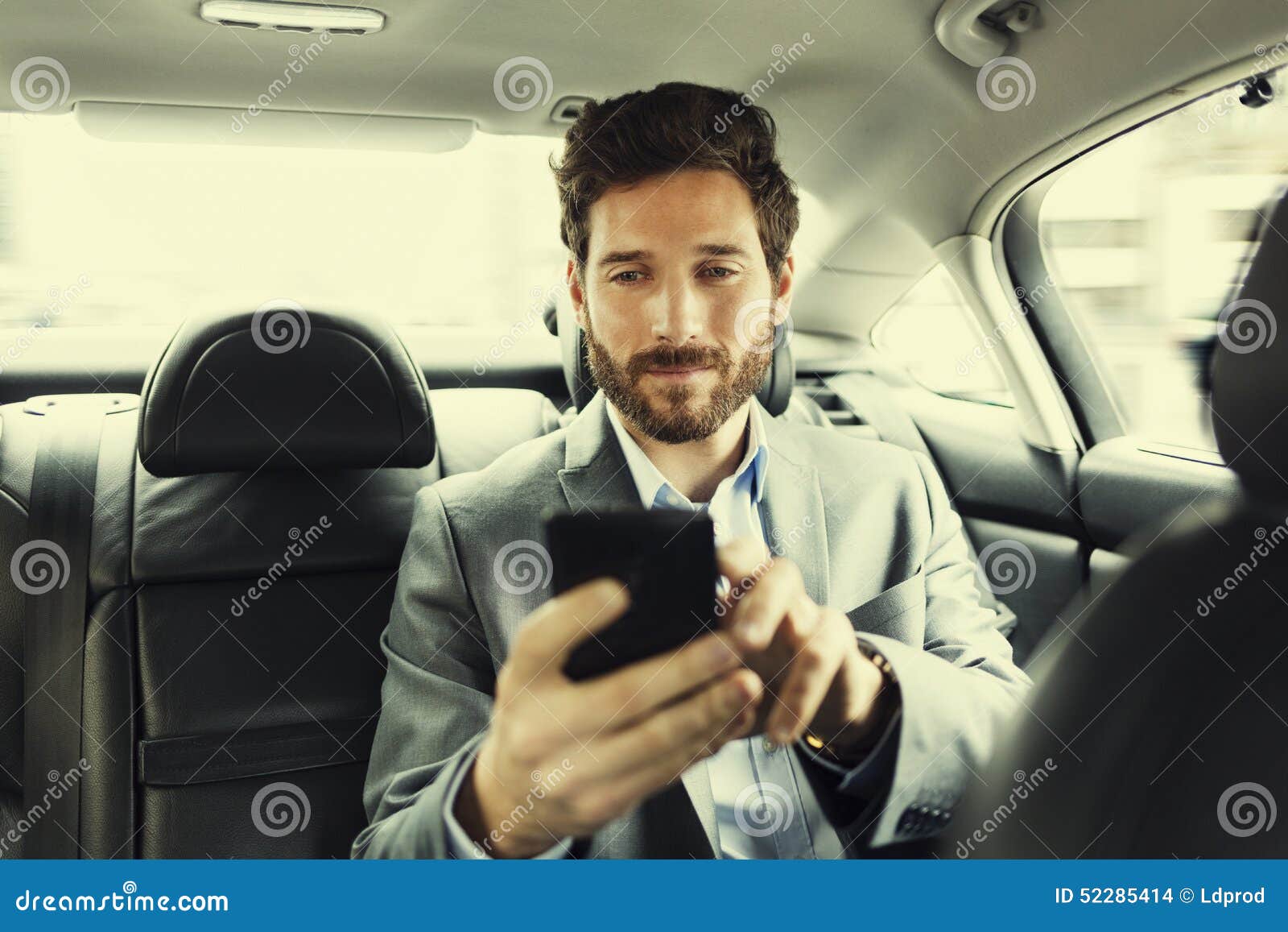 Hipster Man in Car. Typing Text Message on Mobile Phone Stock Photo ...