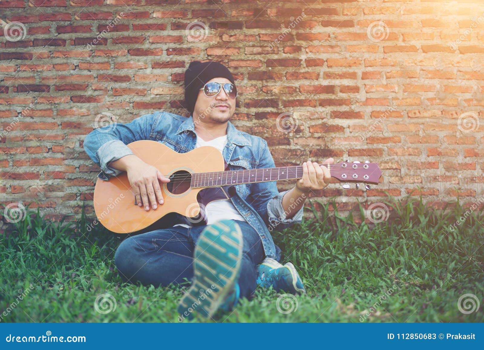 Hipster Man Sitting while Playing Guitar and Singing. Stock Image ...