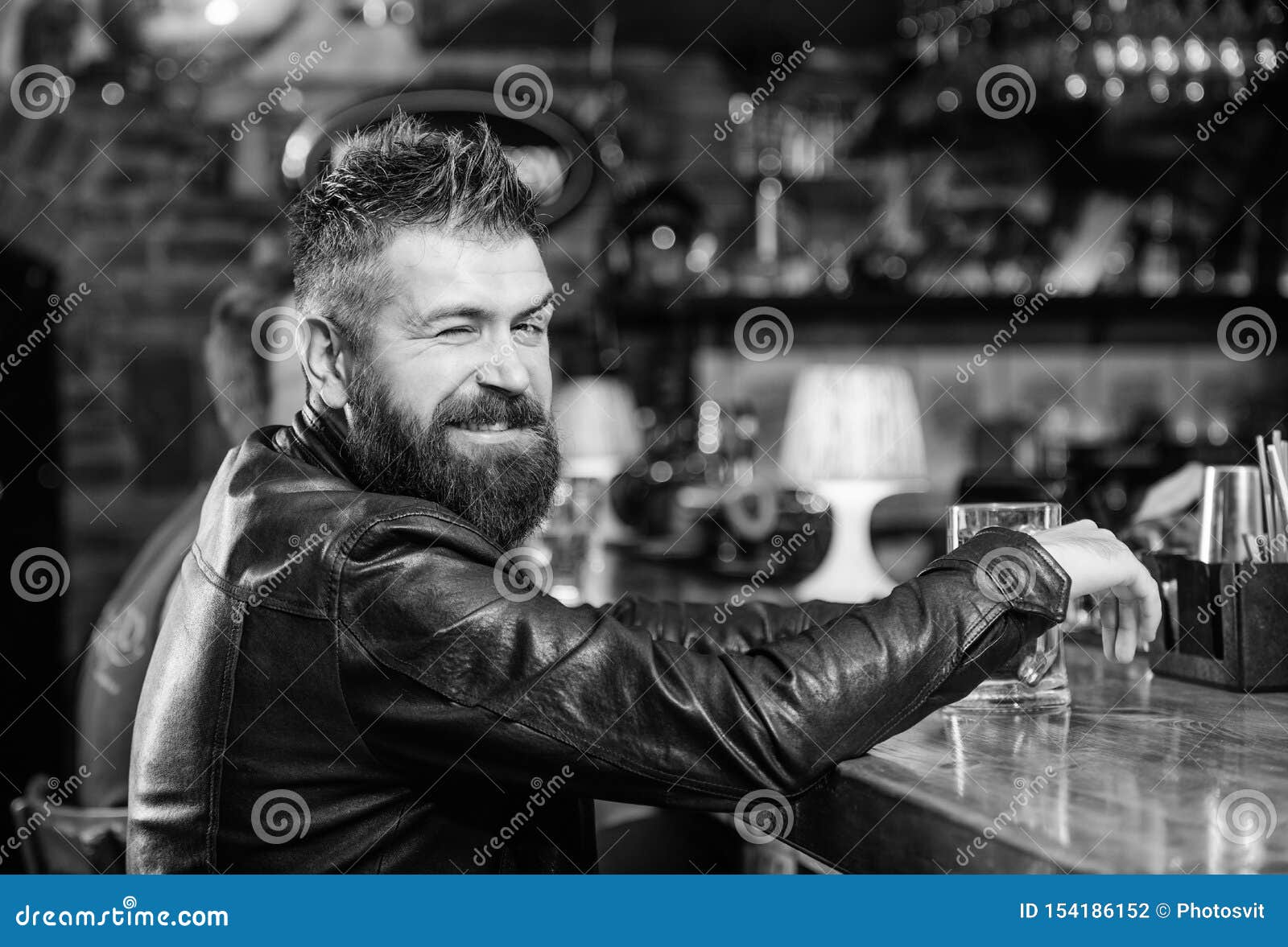 Hipster Relaxing at Bar with Beer. Brutal Hipster Bearded Man Sit at ... Hipster Relaxing at Bar with Beer. Brutal Hipster Bearded Man Sit at ...