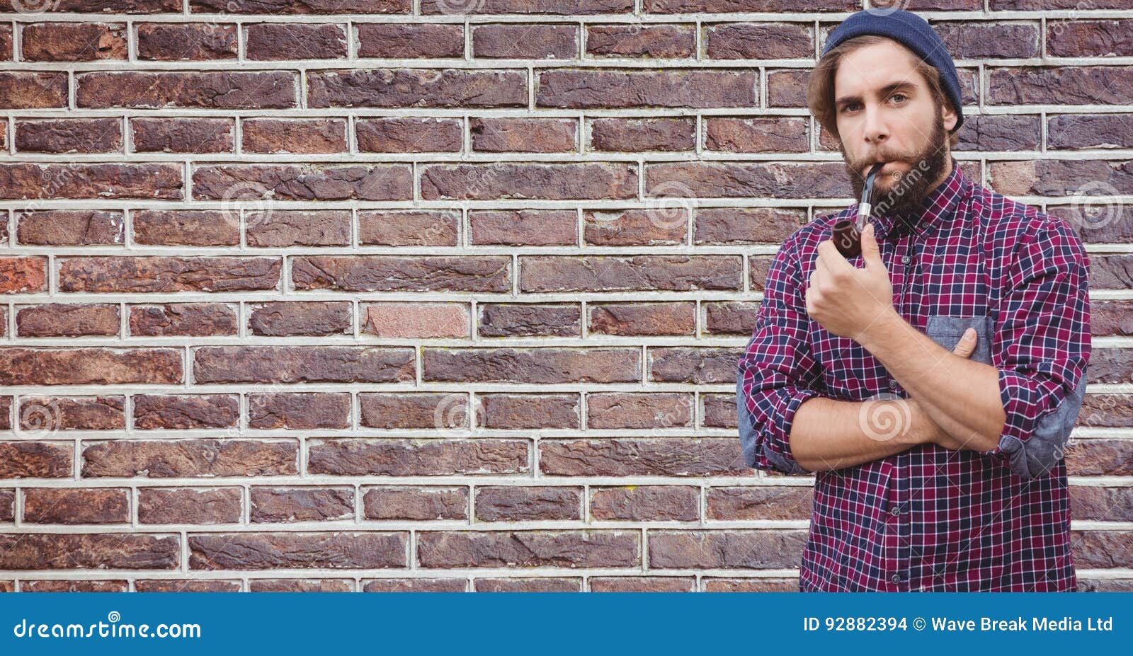 Hipster Smoking Pipe Against Brick Wall Stock Photo - Image of beard ...