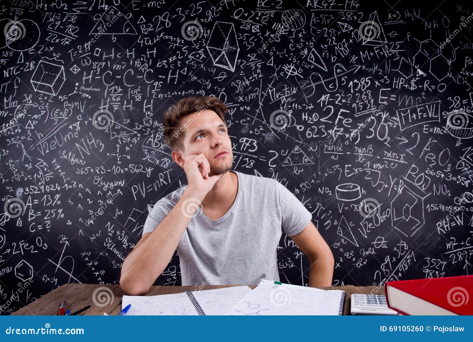 Hipster Student Doing His Homework Against a Big Blackboard Stock Photo ...