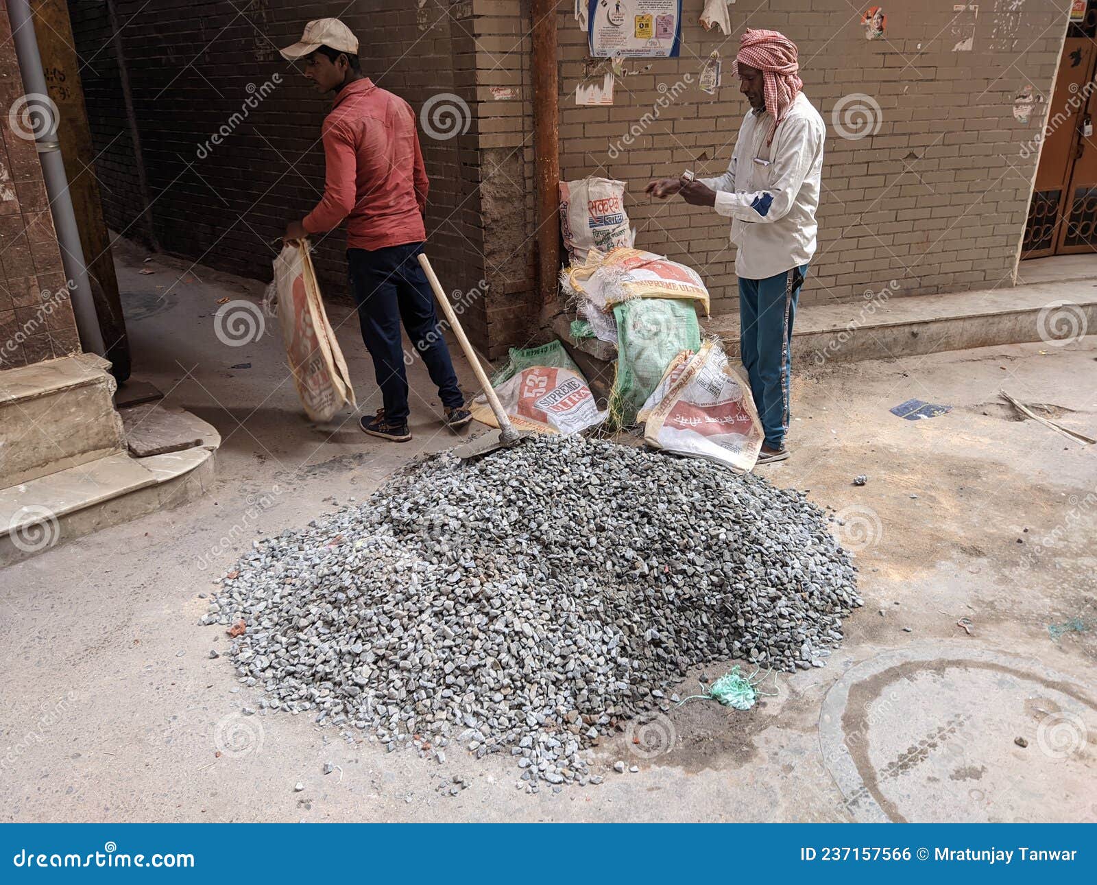 2 Men are Working Around a Pile of Stones (Press Photograph) Editorial ...