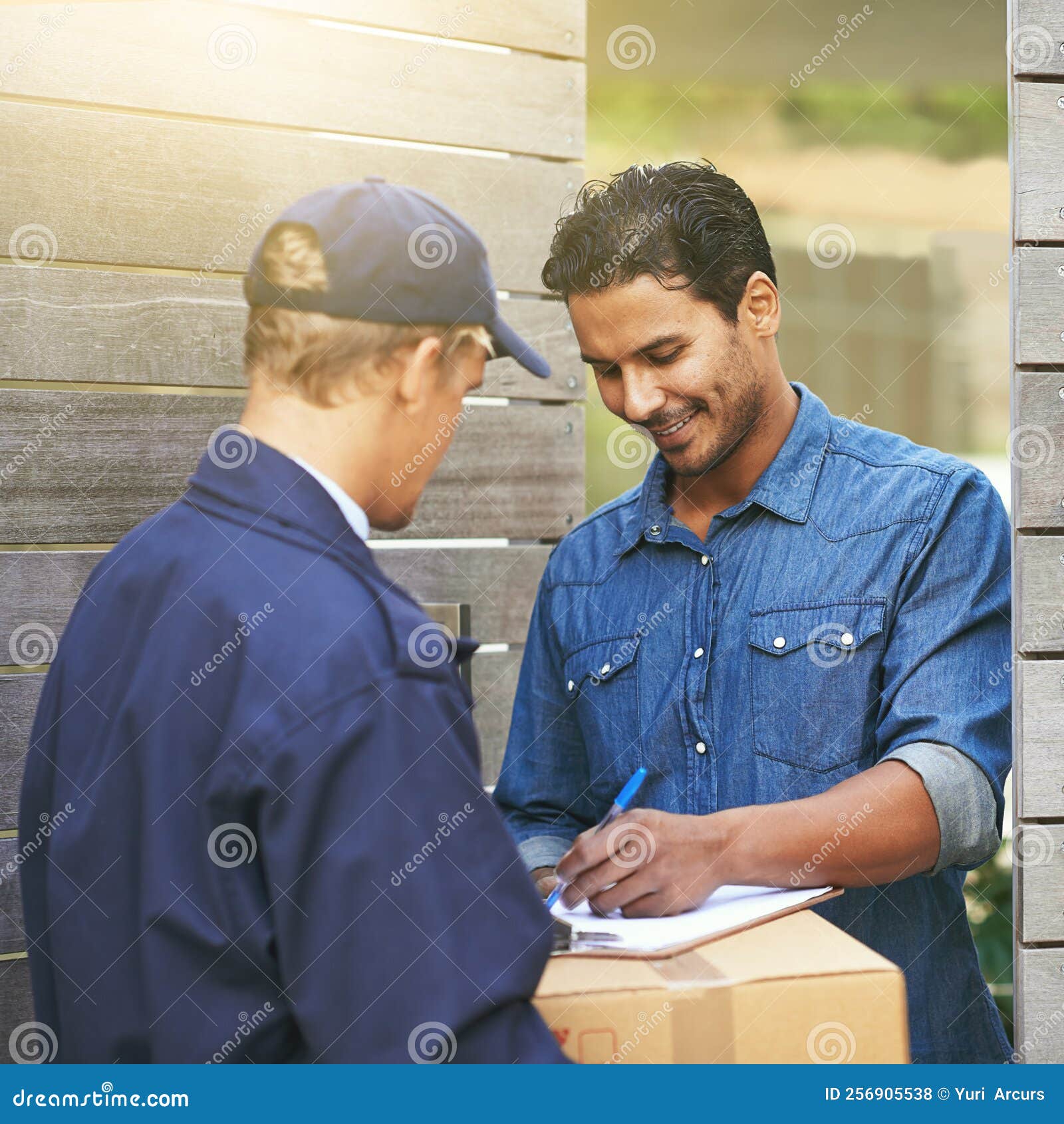 His Package Has Arrived. a Young Man Receiving a Package at Home. Stock ...