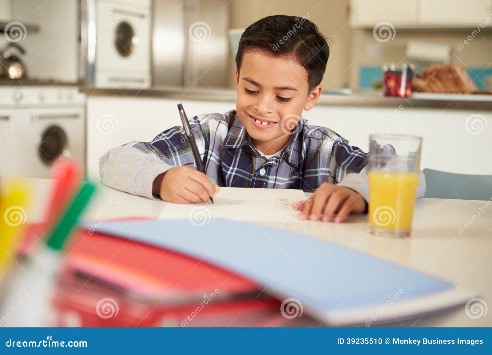 Hispanic Boy Doing Homework at Table Stock Photo - Image of people ...