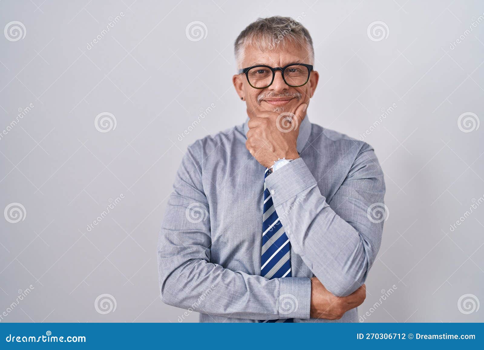 Hispanic Business Man With Grey Hair Wearing Glasses With Hand On Chin