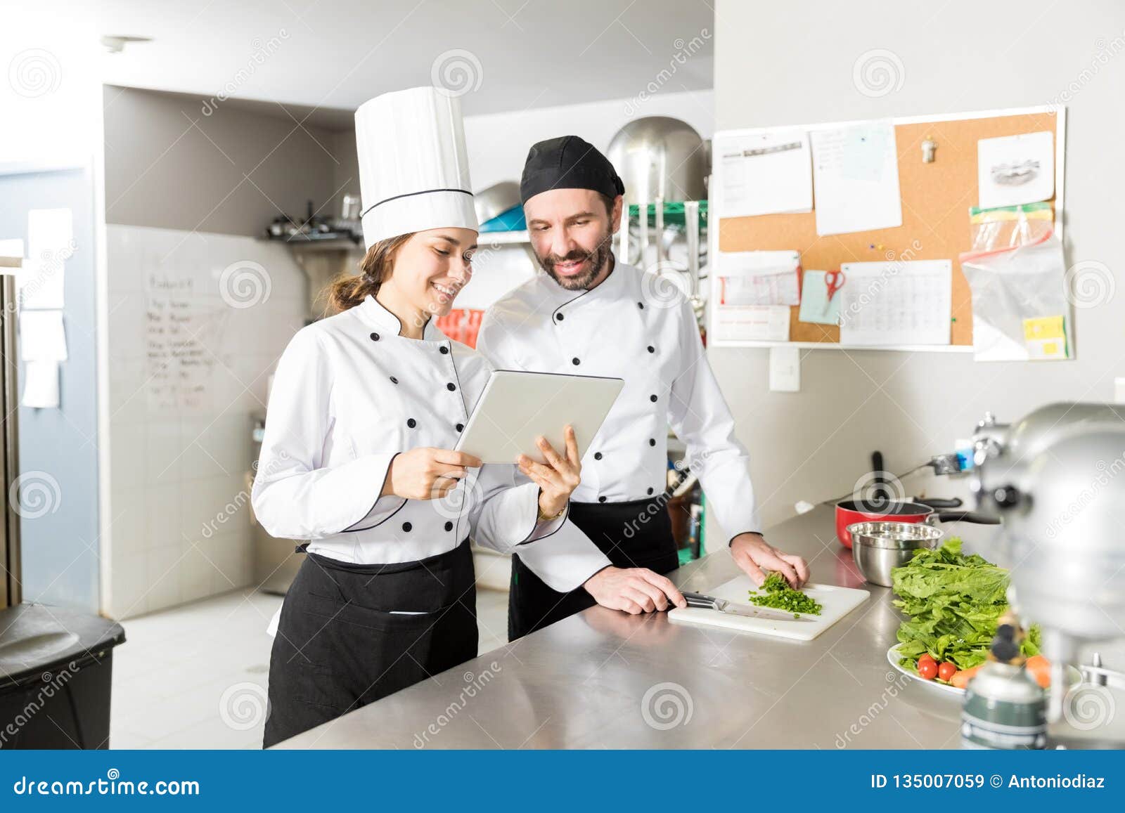 Hispanic Chefs Using Digital Tablet in Kitchen Stock Image - Image of ...
