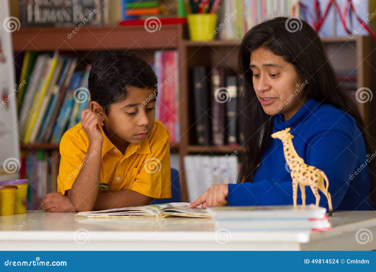 Hispanic Child Learning To Read with Mom Stock Photo - Image of ...