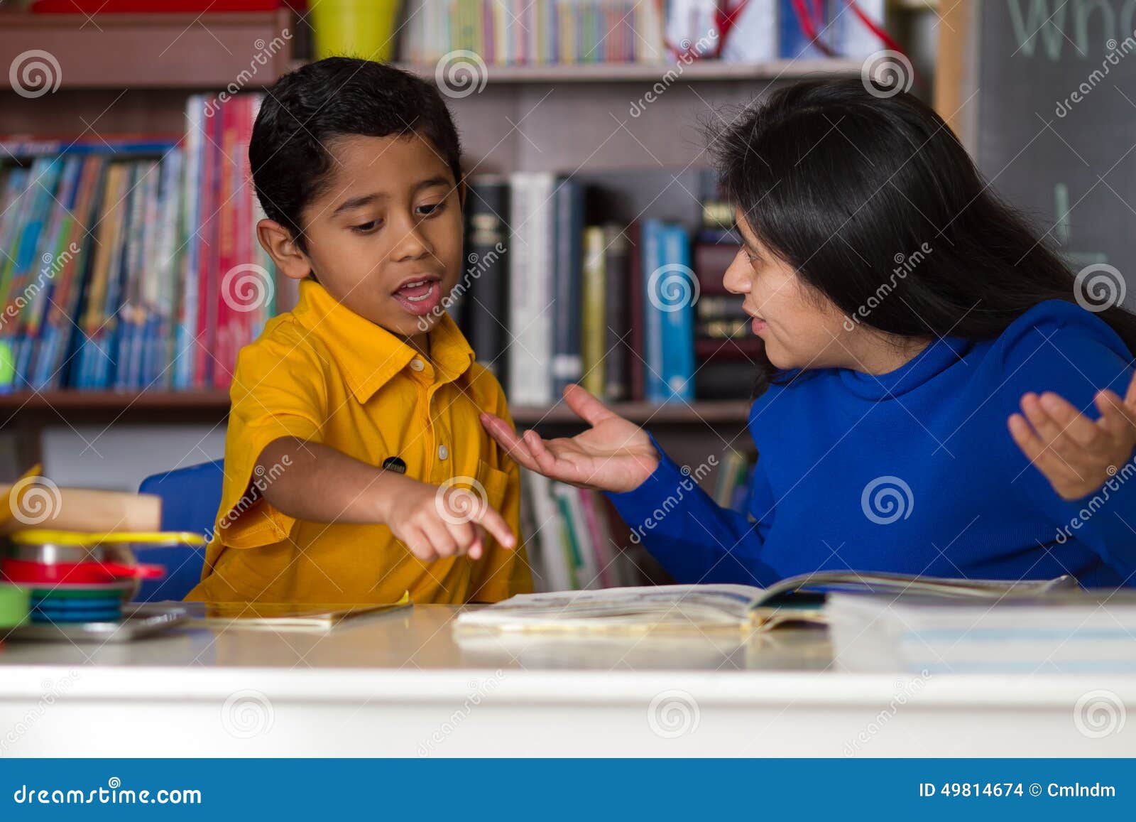 Hispanic Child Reading with Mother Stock Photo - Image of reading, blue ...