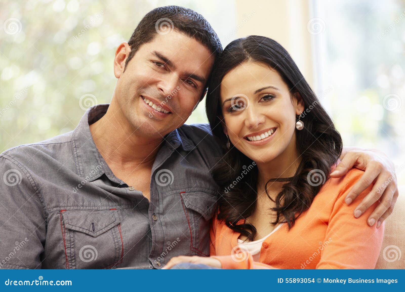 Hispanic couple at home stock photo. Image of indoors - 55893054