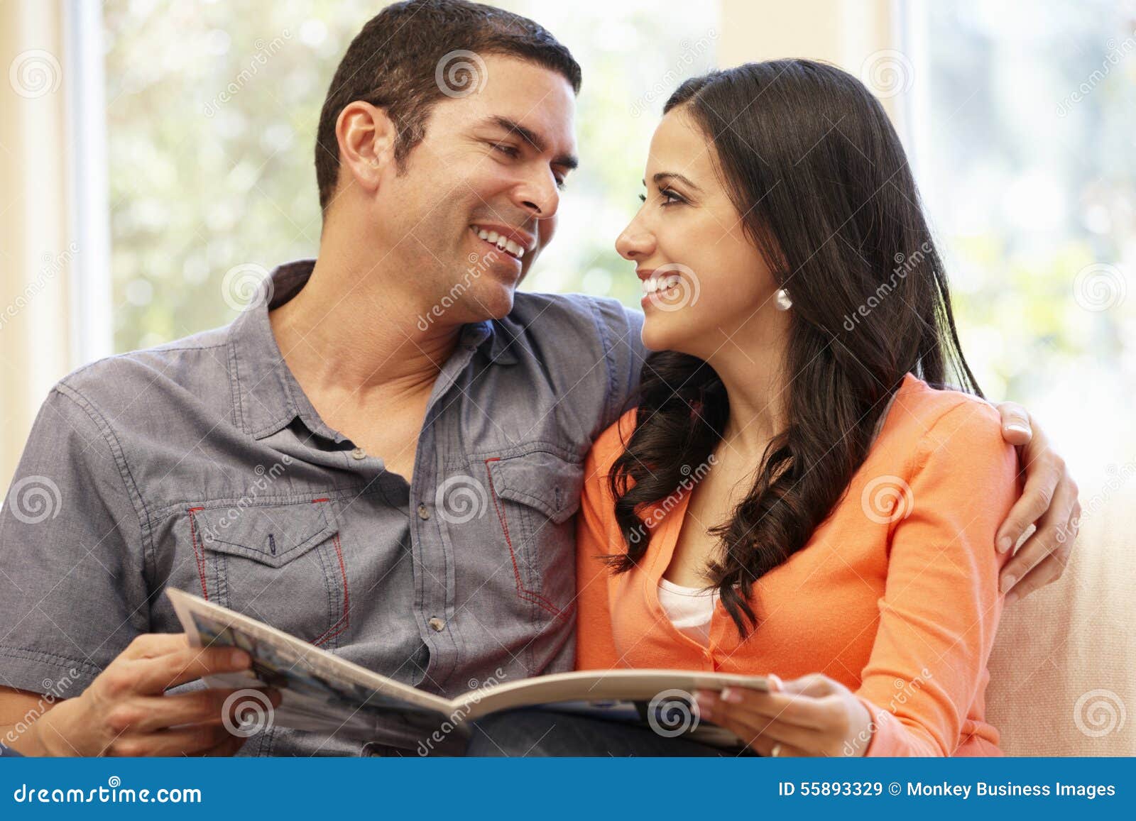 Hispanic Couple at Home Reading Magazine Stock Image - Image of home ...