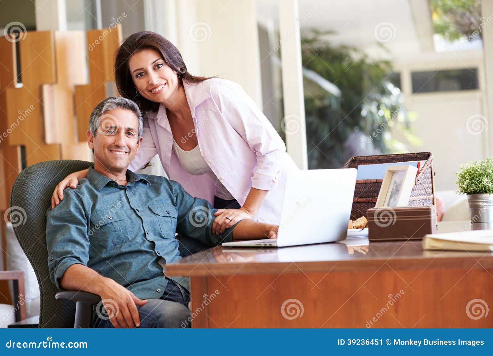Hispanic Couple Using Laptop on Desk at Home Stock Image - Image of ...