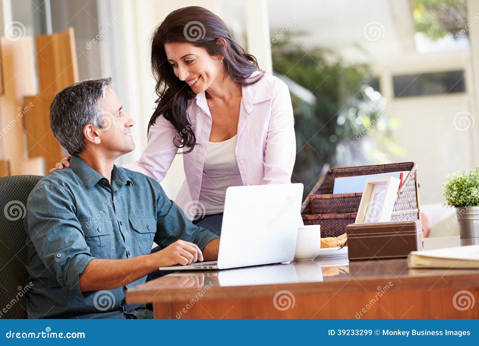 Hispanic Couple Using Laptop on Desk at Home Stock Image - Image of ...