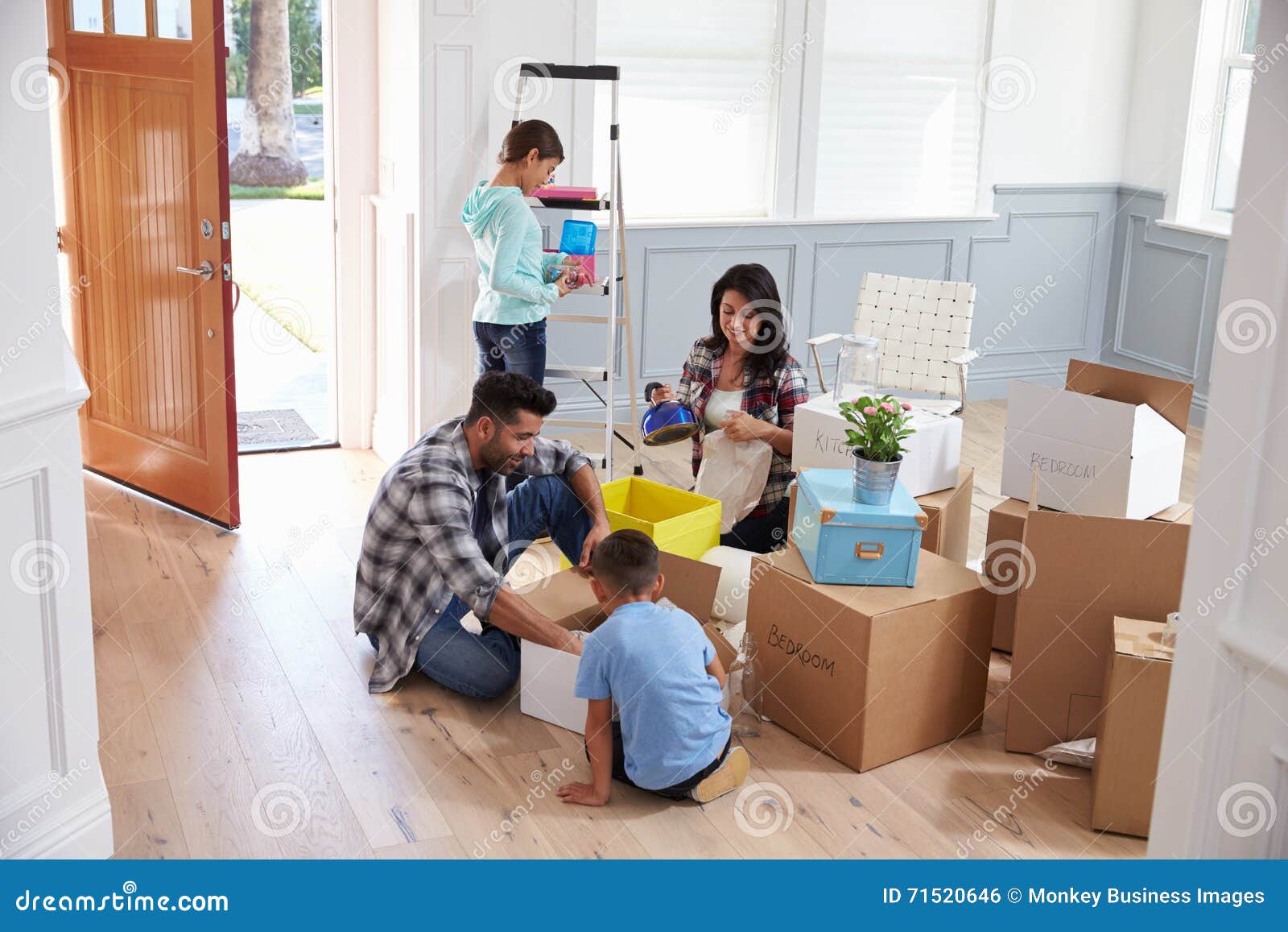 Hispanic Family Moving into New Home Stock Photo - Image of smiling ...