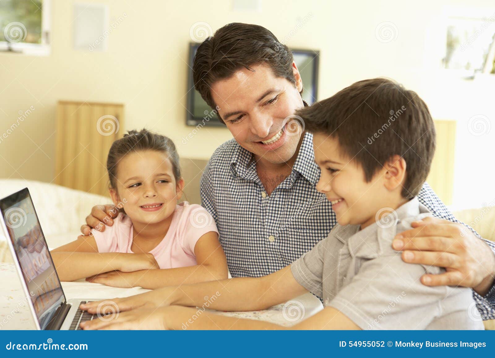 Hispanic Father and Children Using Computer at Home Stock Photo - Image ...