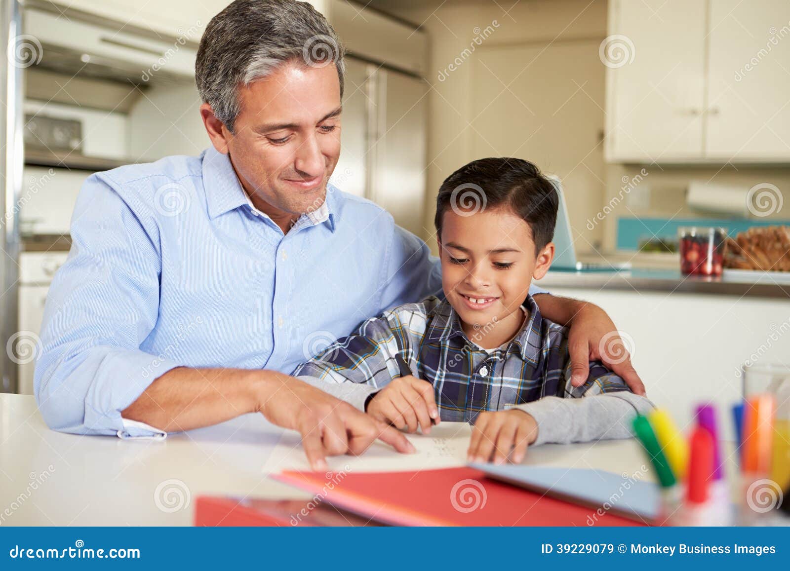 Hispanic Father Helping Son with Homework at Table Stock Image - Image ...