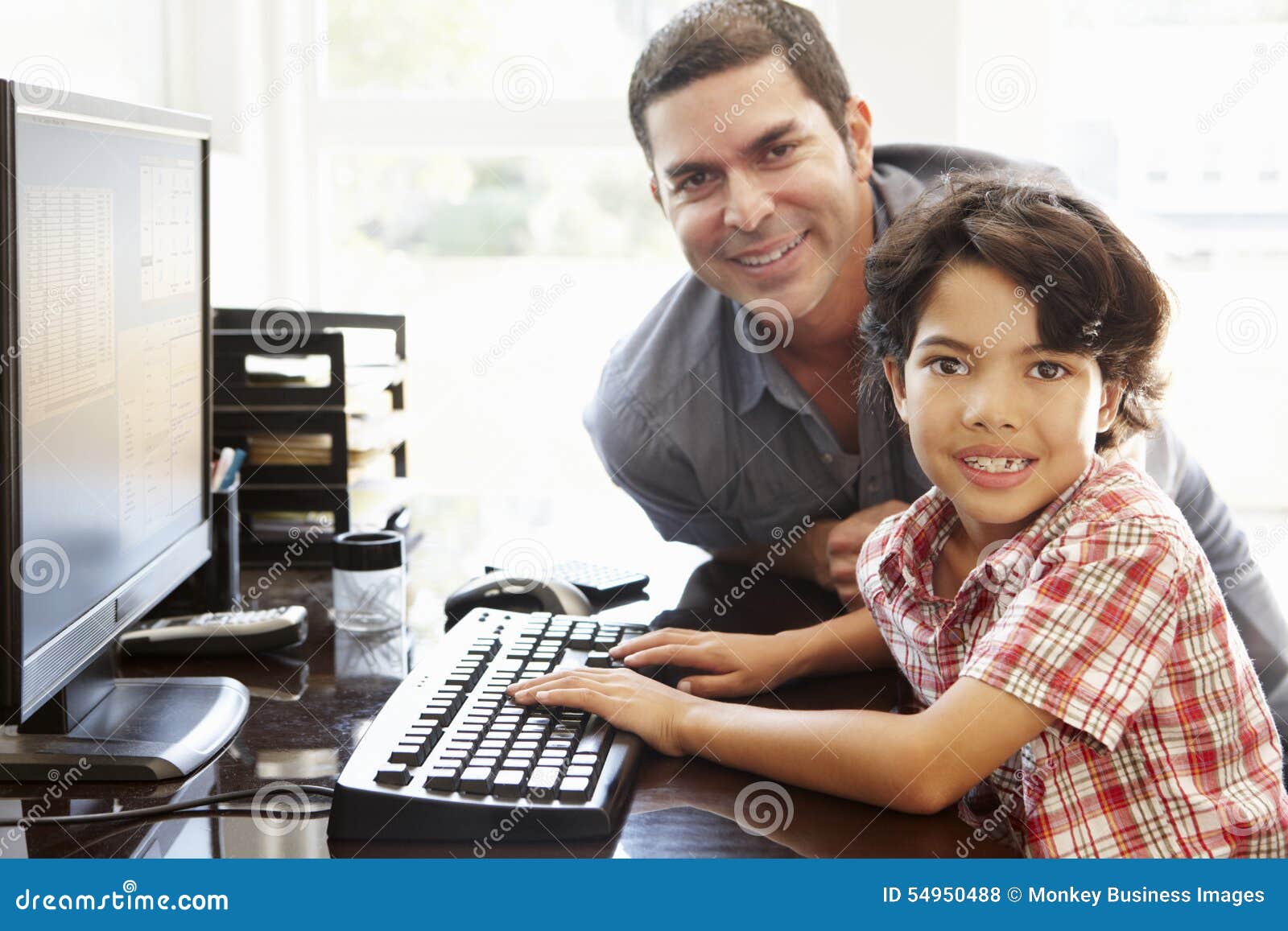 Hispanic Father and Son Using Computer at Home Stock Photo - Image of ...