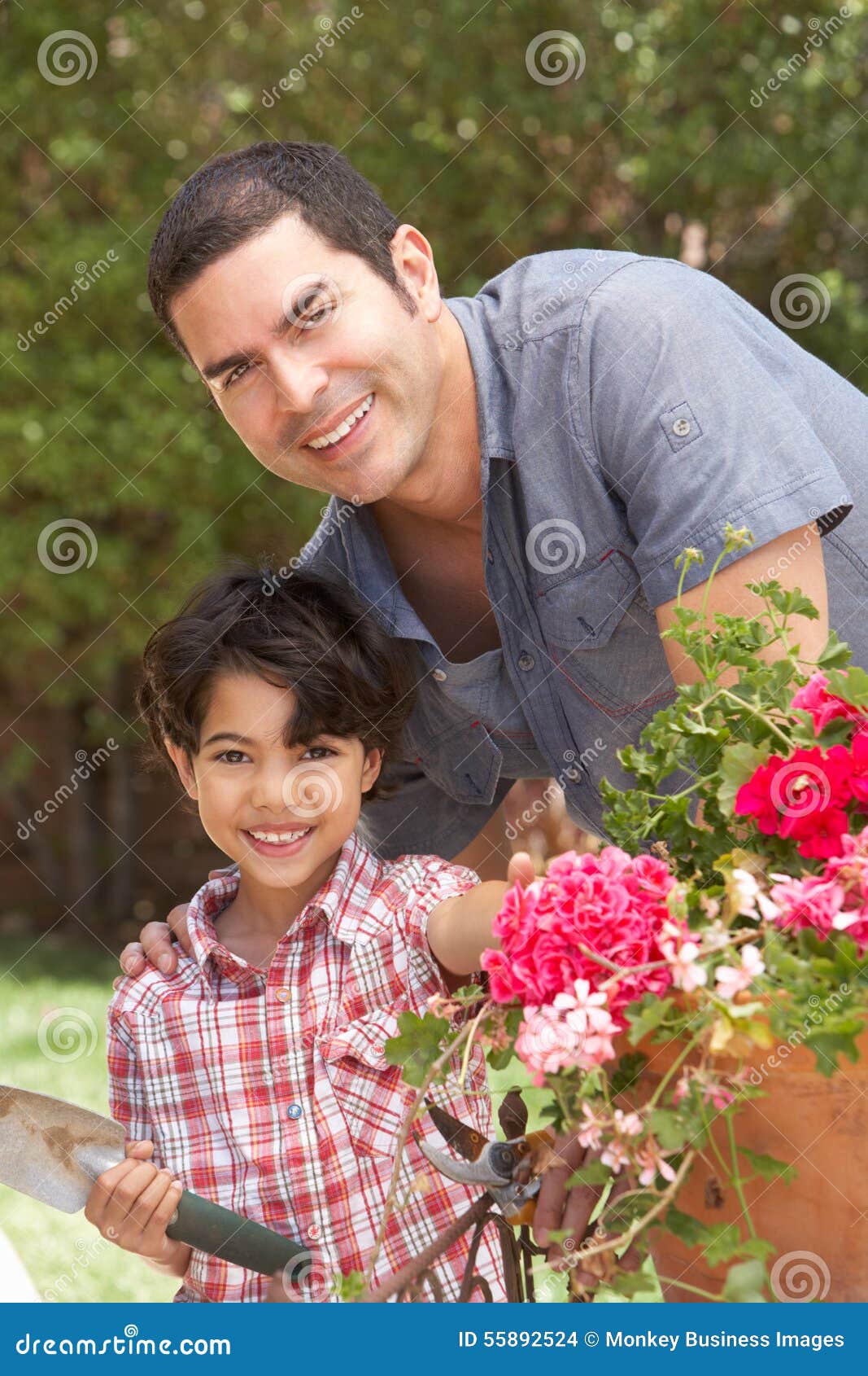 Hispanic Father and Son Working in Garden Tidying Pots Stock Photo ...