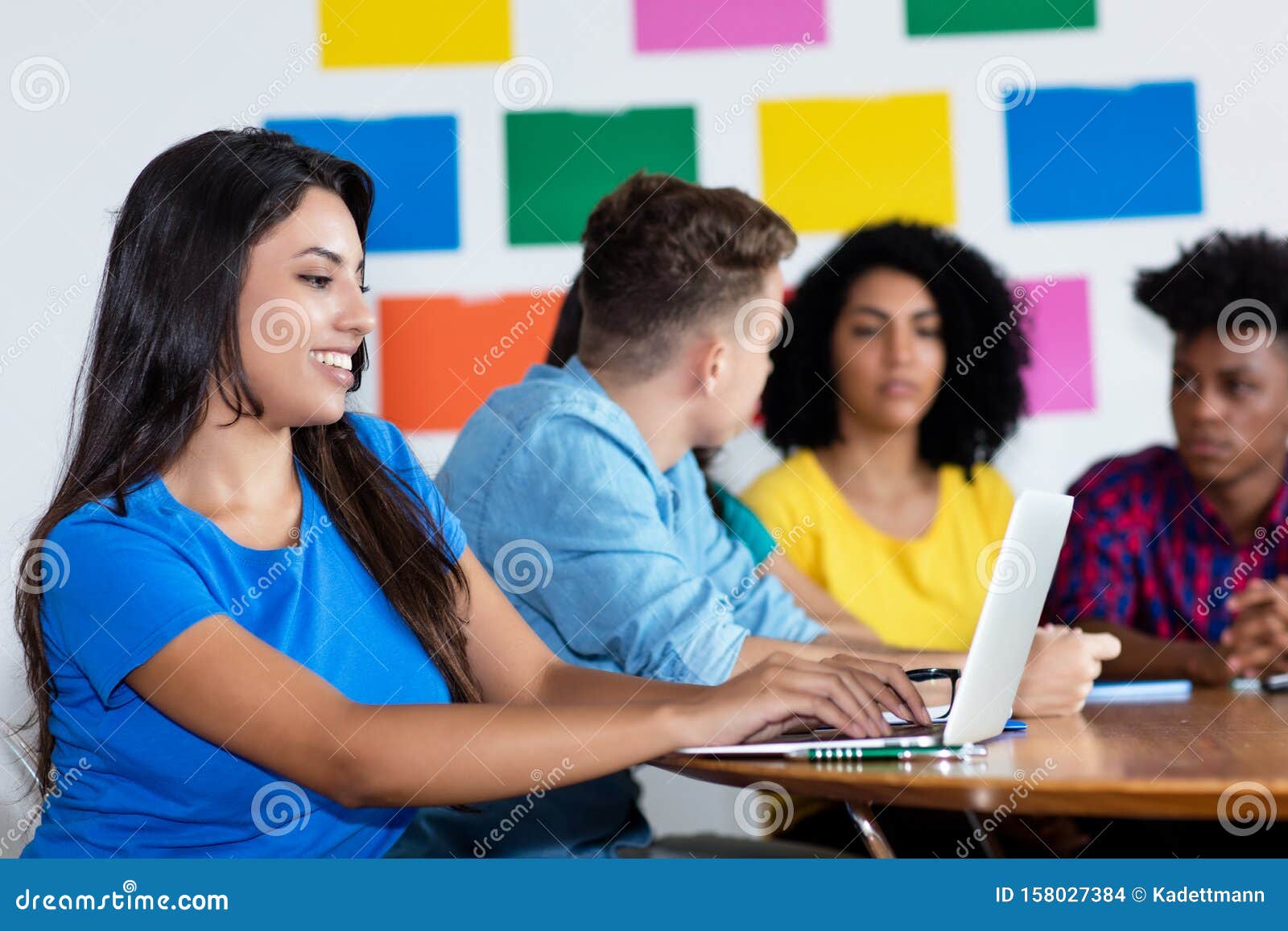 Hispanic Female Student at Computer with Group of Students Stock Photo ...