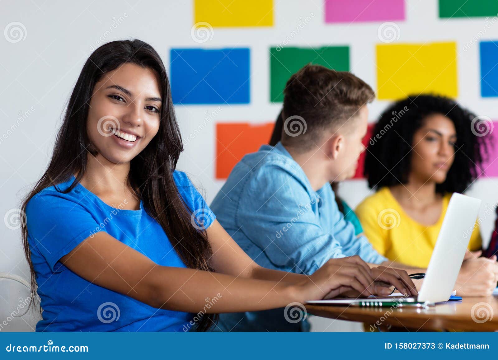 Hispanic Female Student Learning with Group of Students Stock Image ...