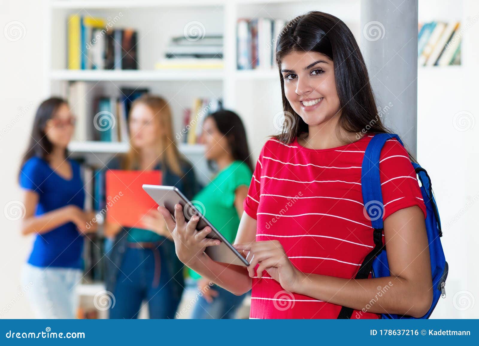 Hispanic Female Student with Tablet Computer with Group of Multi Ethnic ...