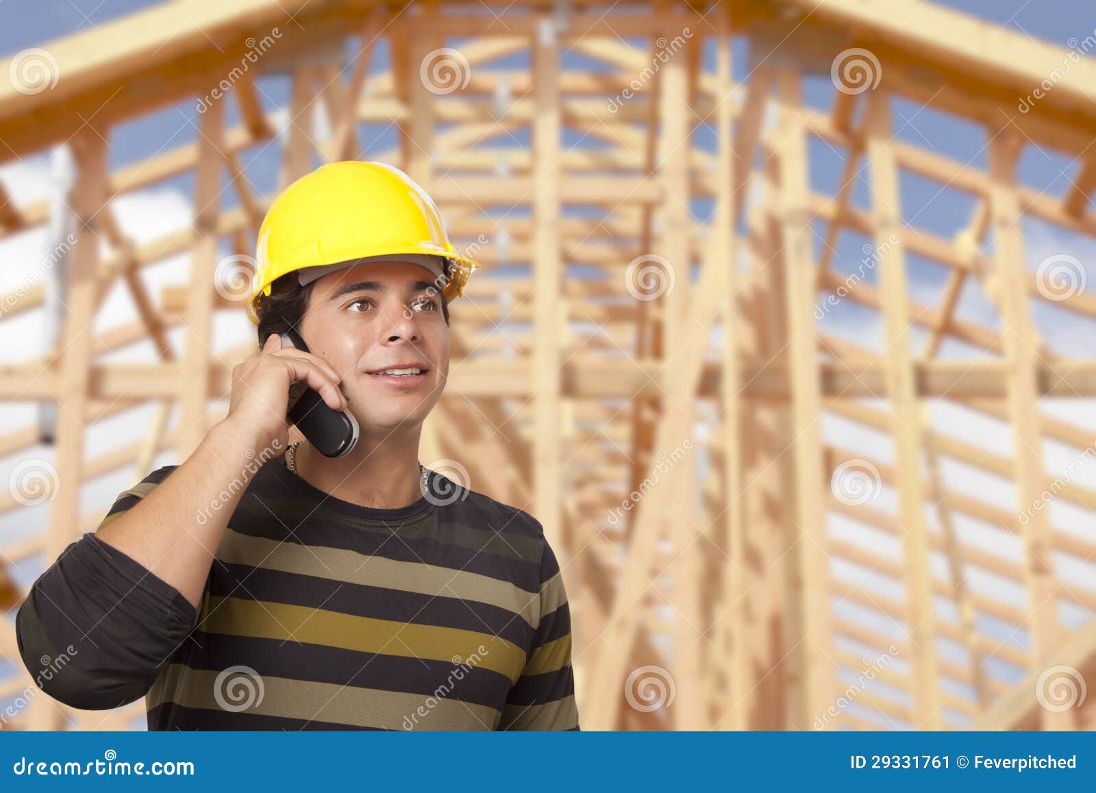 Hispanic Male Contractor on Phone in Front of House Framing Stock Image ...