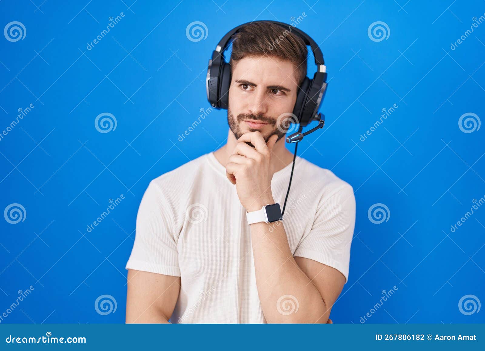 Hispanic Man With Beard Listening To Music Wearing Headphones Looking