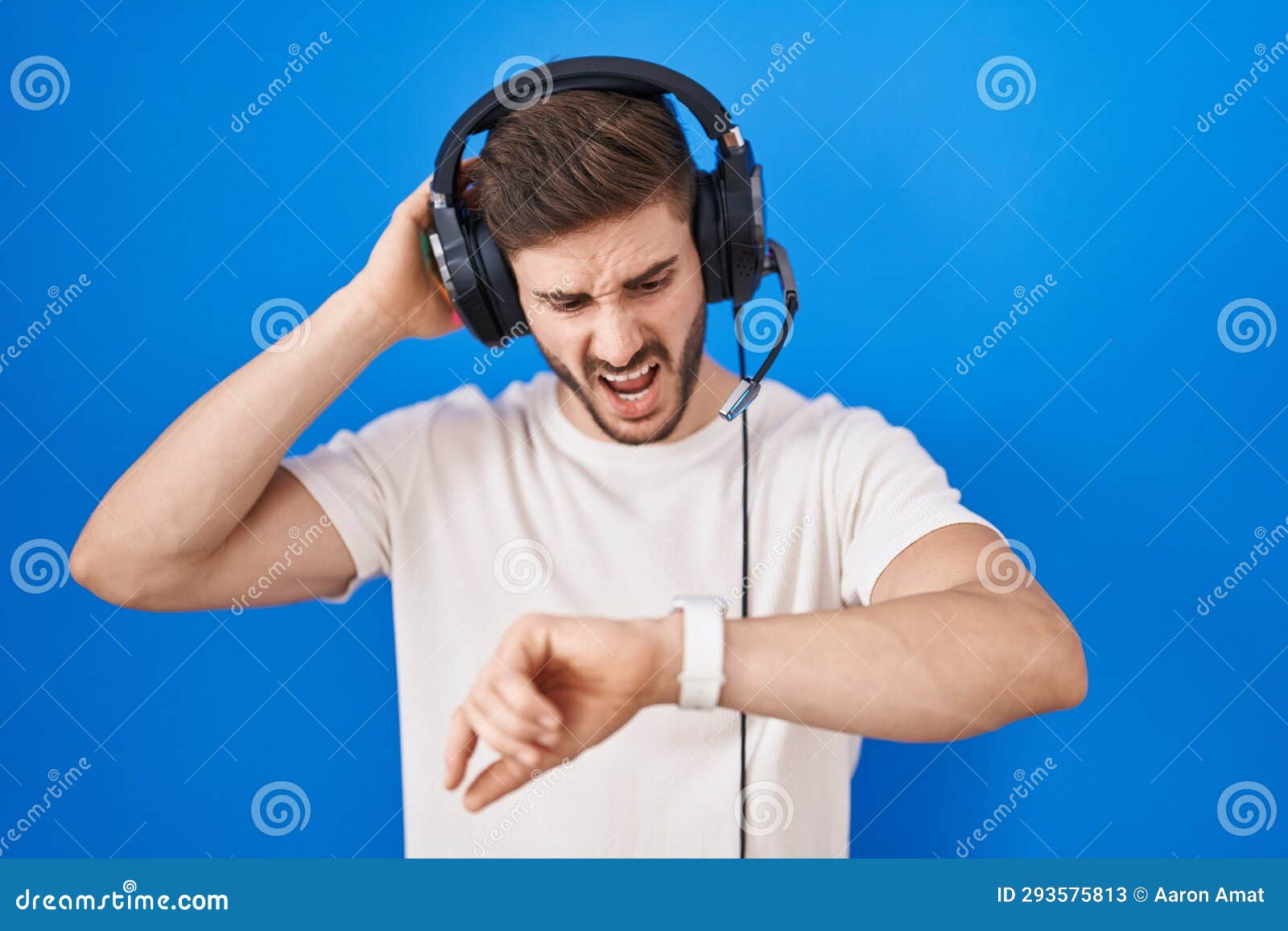 Hispanic Man With Beard Listening To Music Wearing Headphones Looking