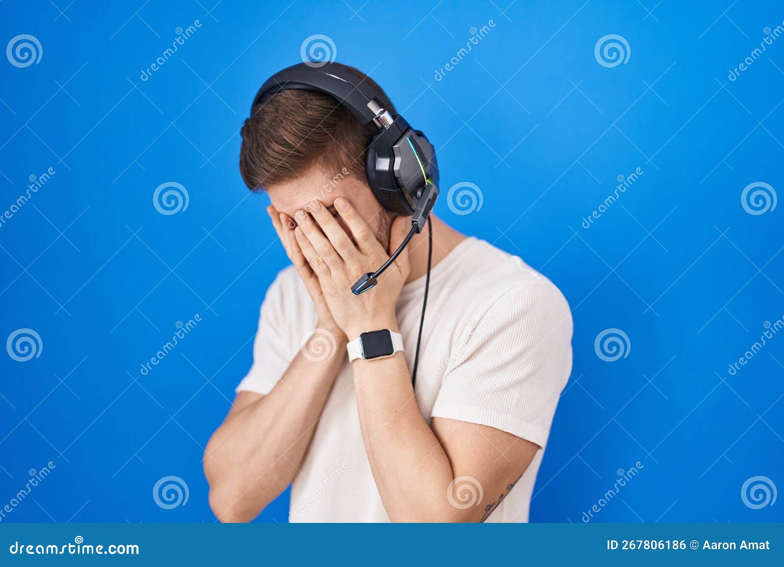 Hispanic Man With Beard Listening To Music Wearing Headphones With Sad