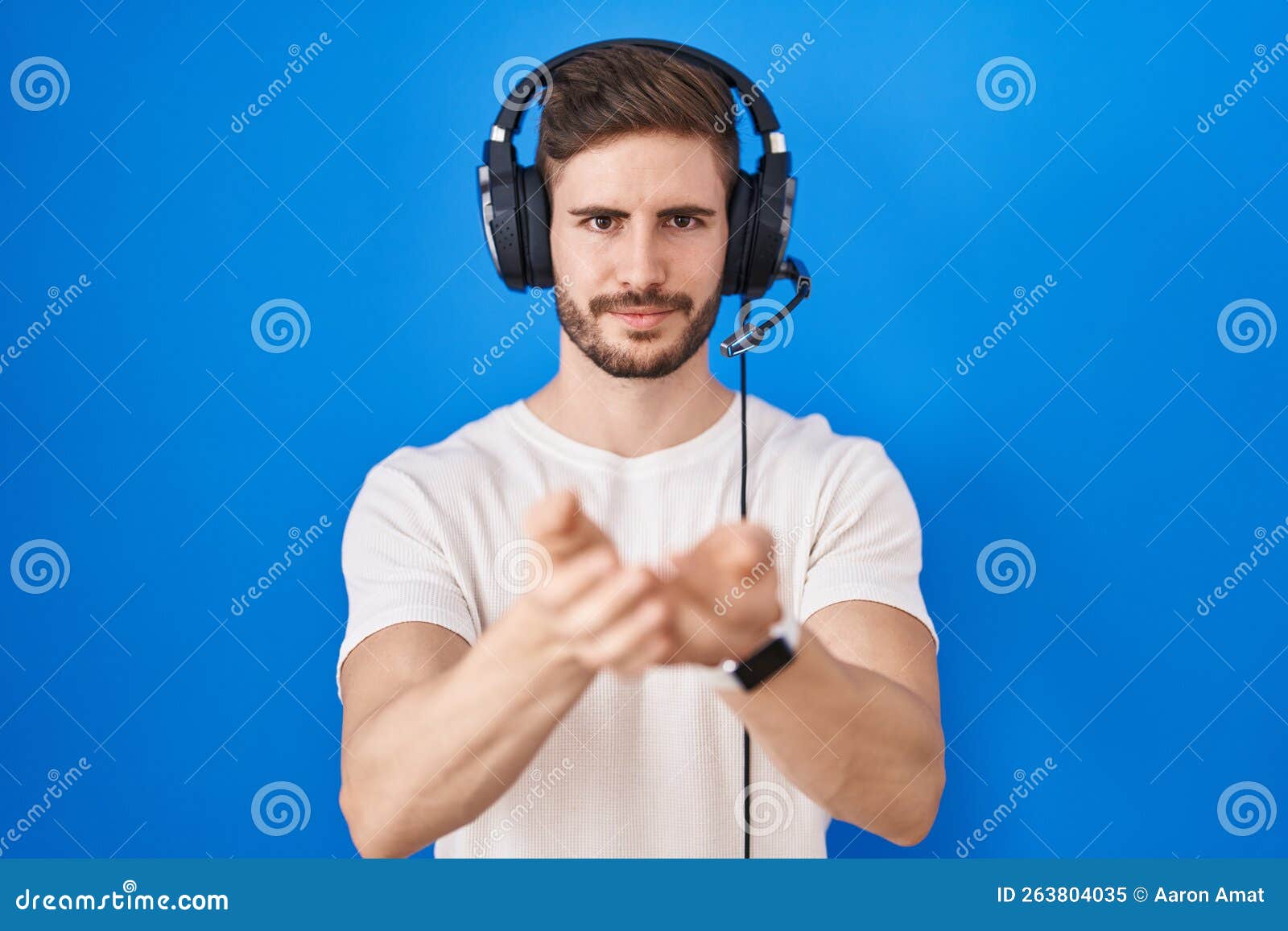 Hispanic Man With Beard Listening To Music Wearing Headphones Smiling