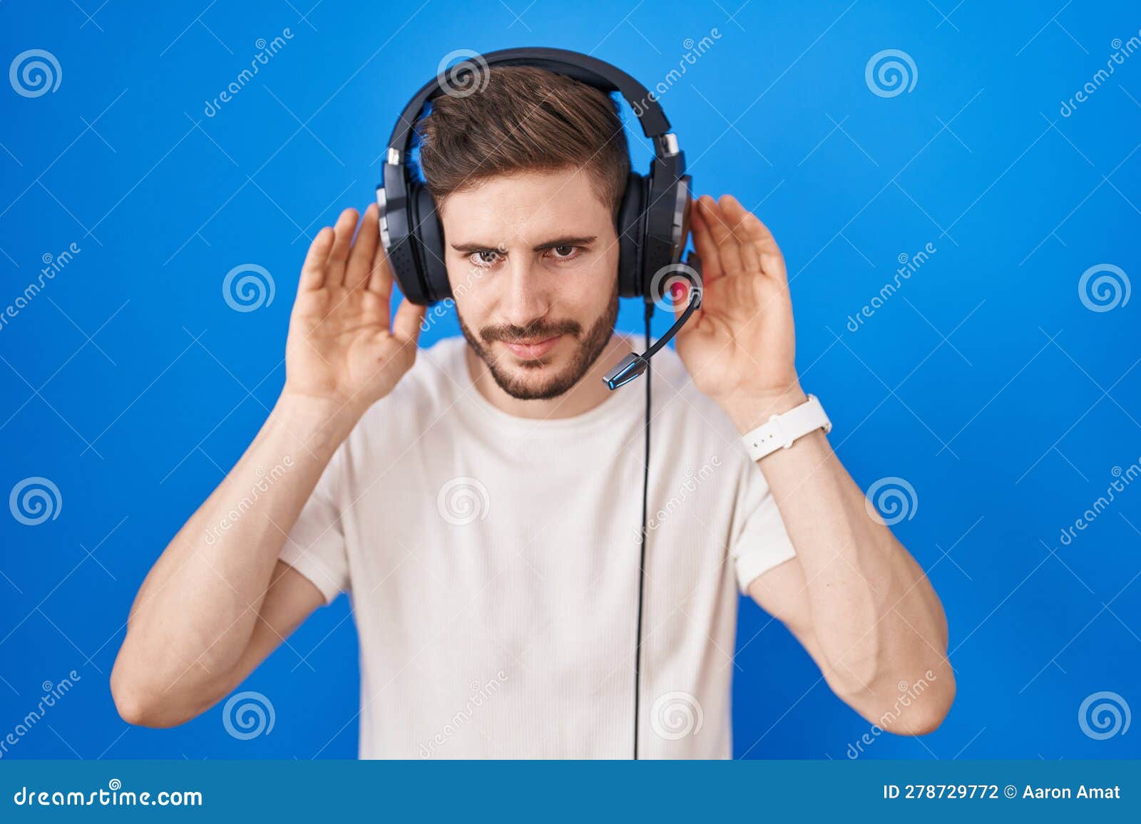 Hispanic Man With Beard Listening To Music Wearing Headphones Trying To