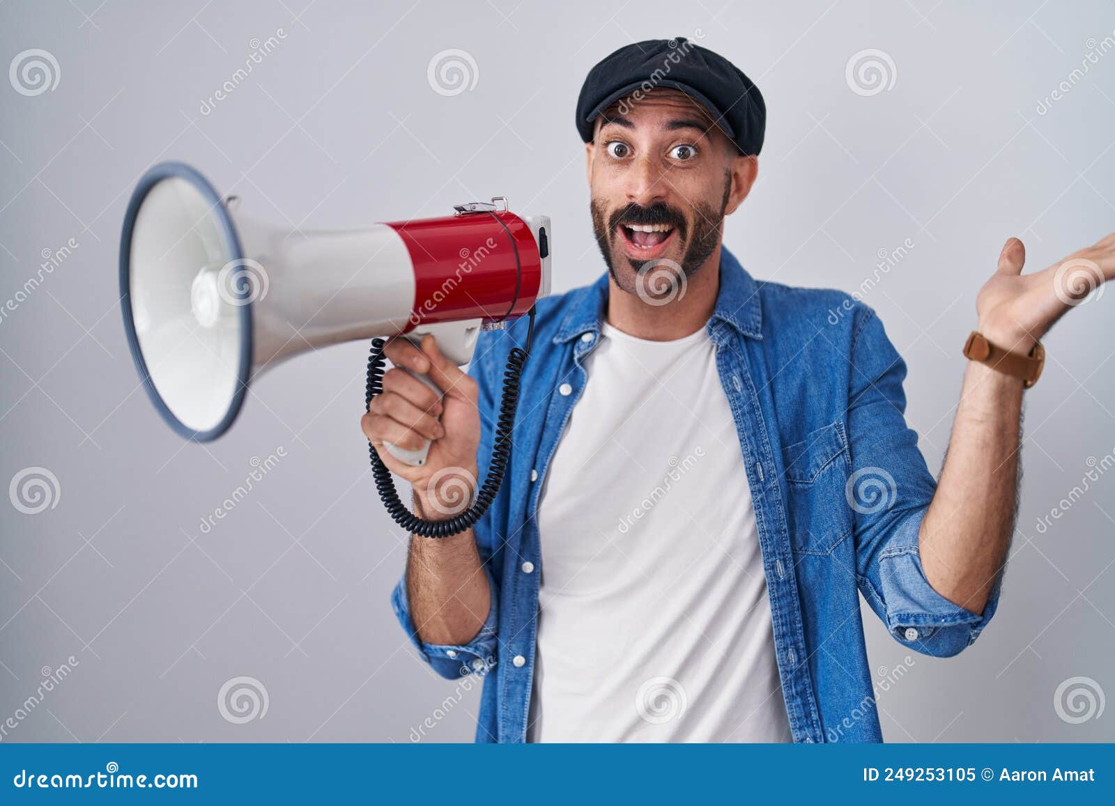 Hispanic Man with Beard Shouting through Megaphone Celebrating Victory ...
