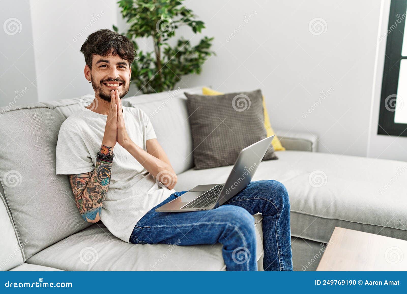Hispanic Man with Beard Sitting on the Sofa Praying with Hands Together ...