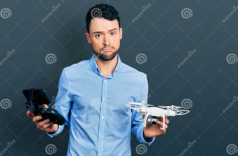 Hispanic Man with Beard Using Drone with Remote Control Depressed and ...