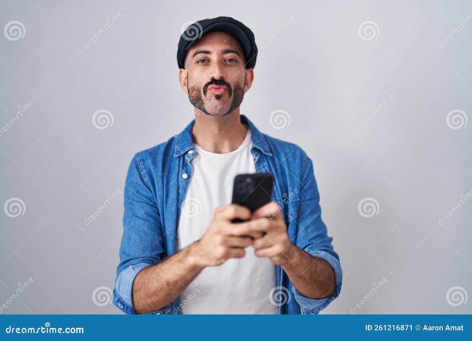 Hispanic Man With Beard Using Smartphone Typing Message Looking At The