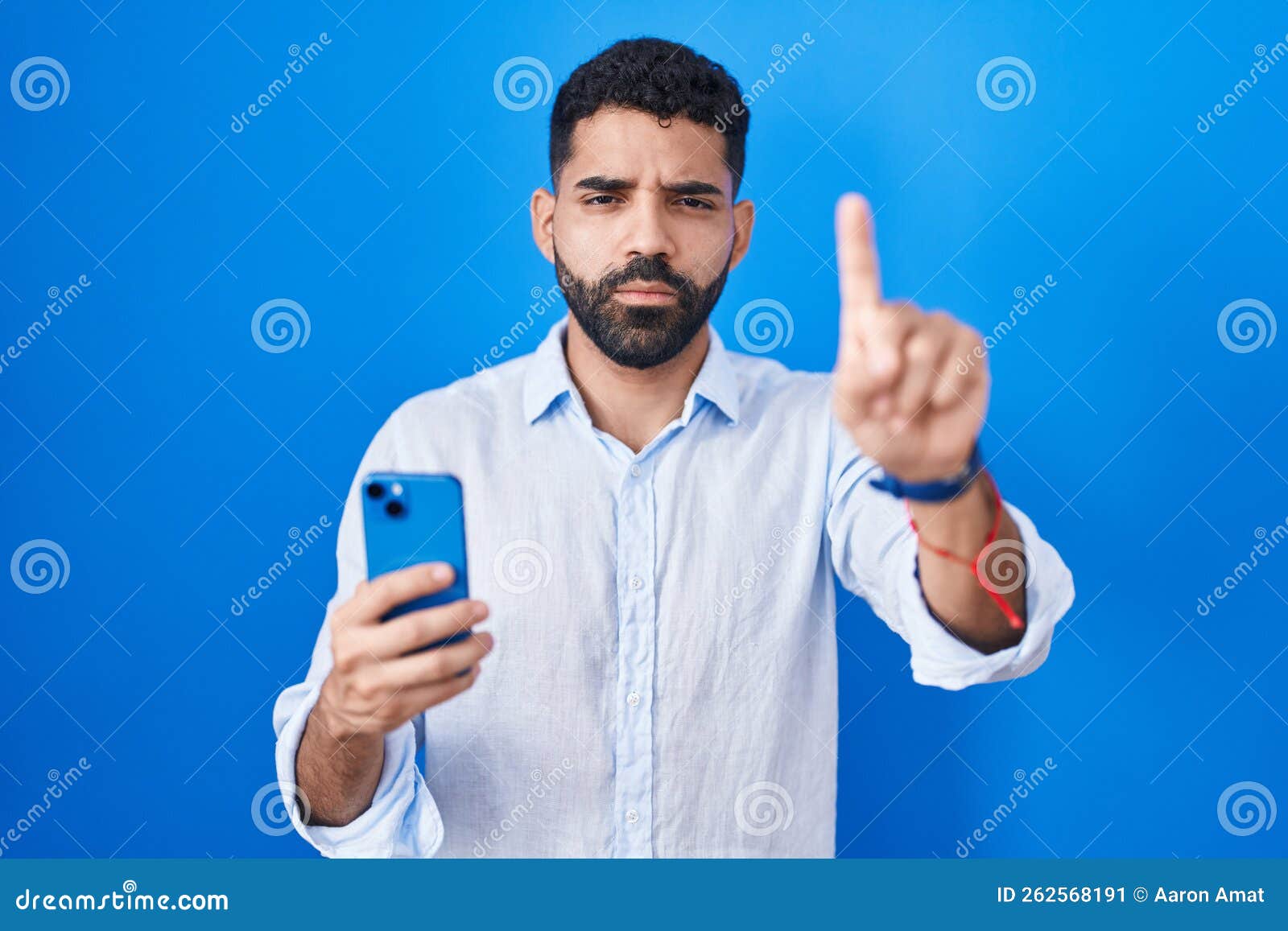 Hispanic Man With Beard Using Smartphone Typing Message Pointing With