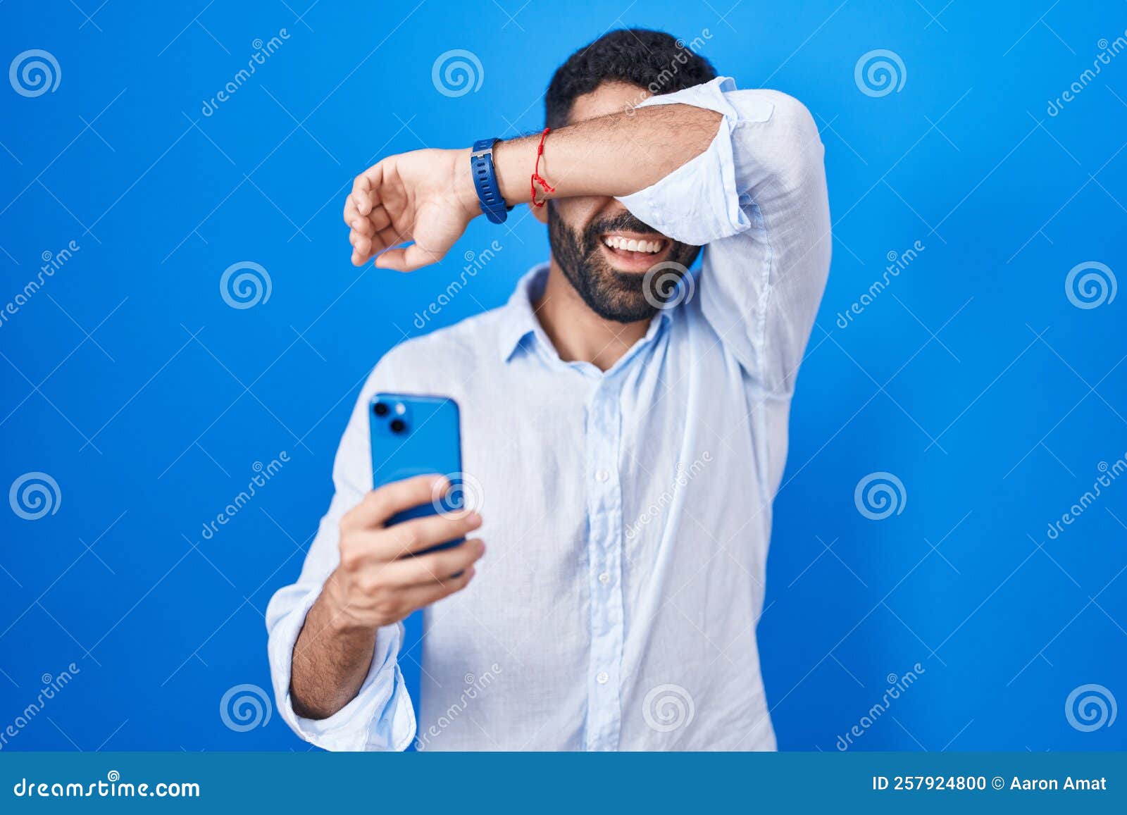 Hispanic Man With Beard Using Smartphone Typing Message Smiling