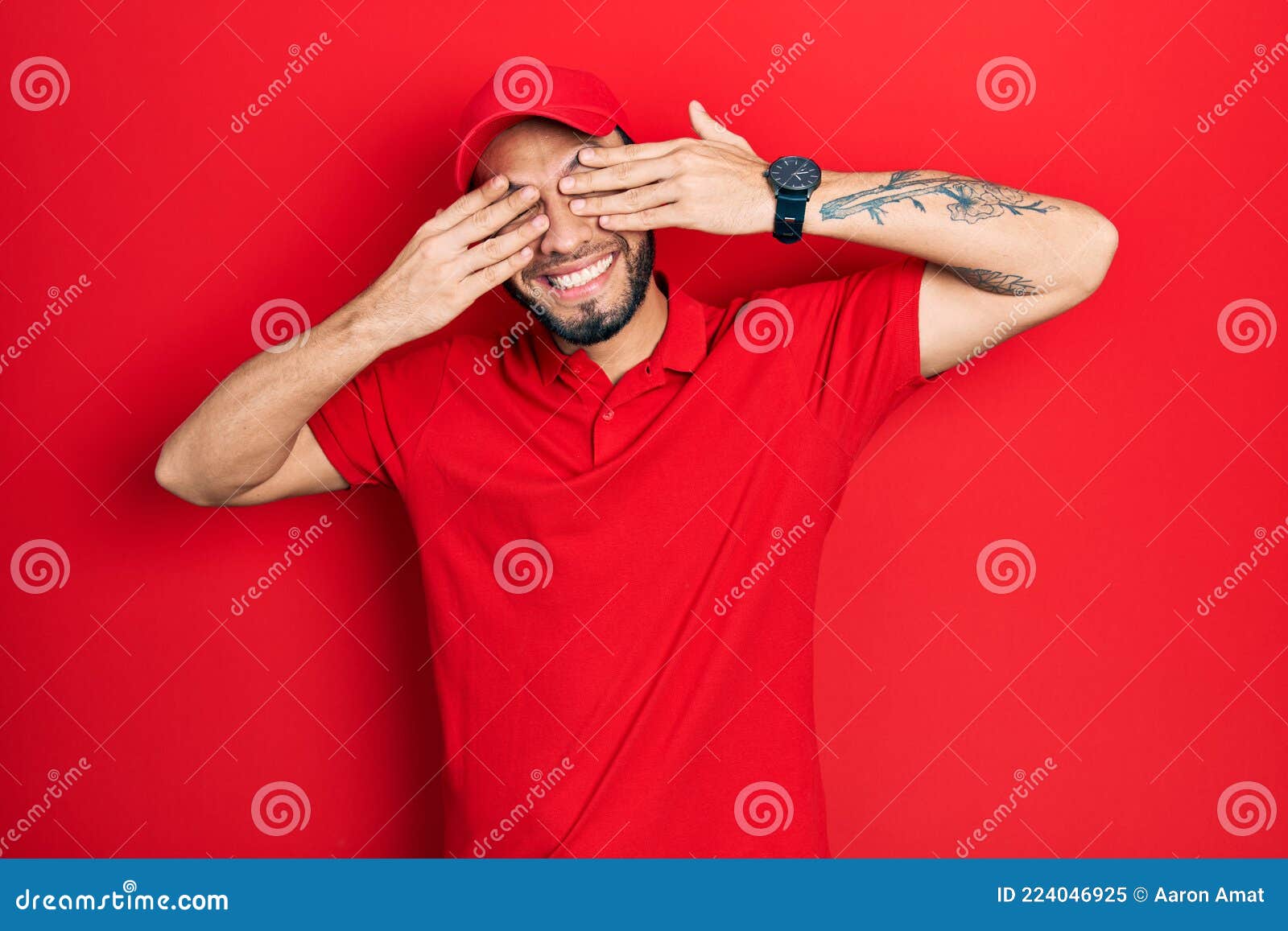 Hispanic Man With Beard Wearing Delivery Uniform And Cap Covering Eyes