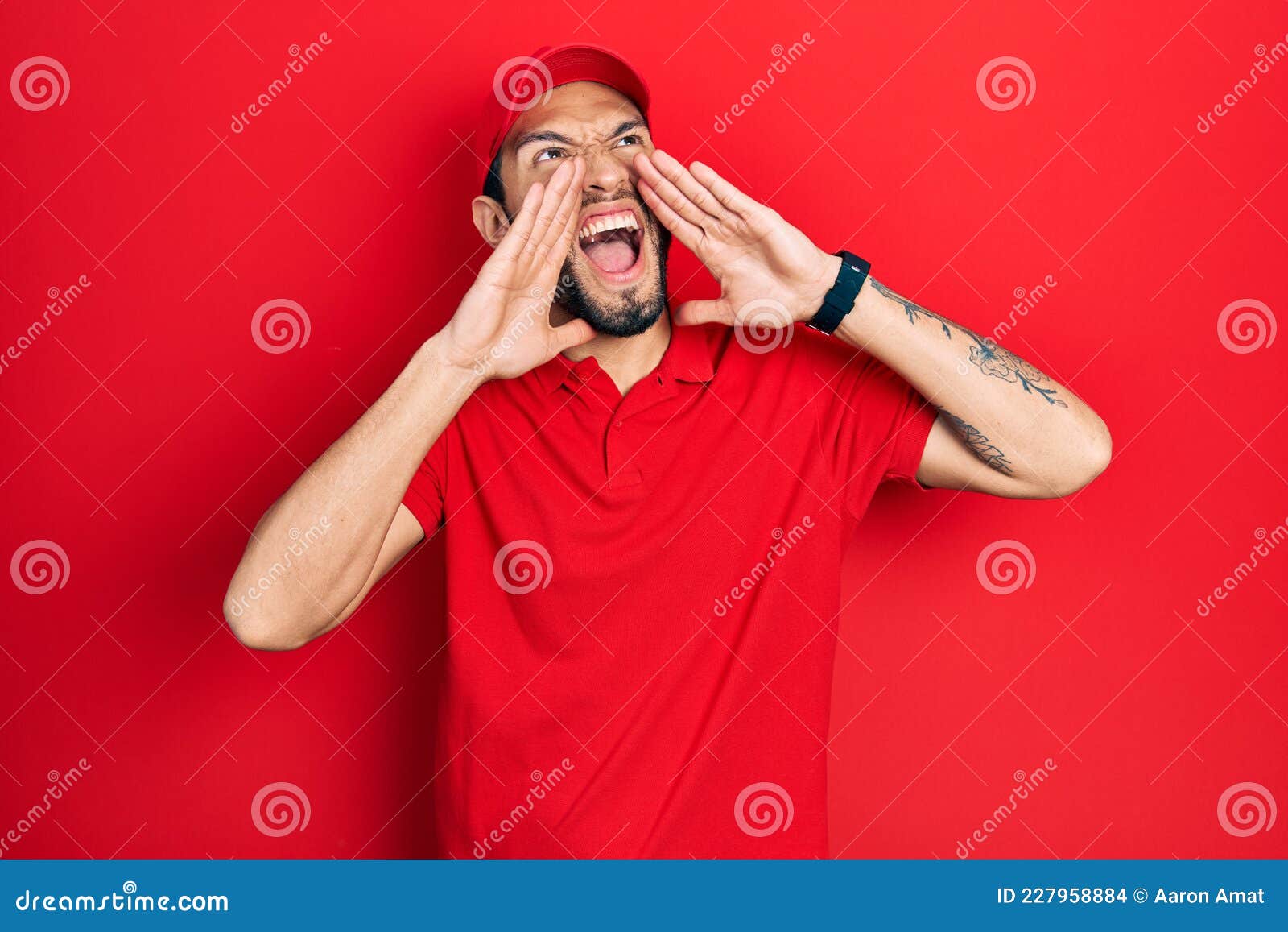 Hispanic Man With Beard Wearing Delivery Uniform And Cap Shouting Angry