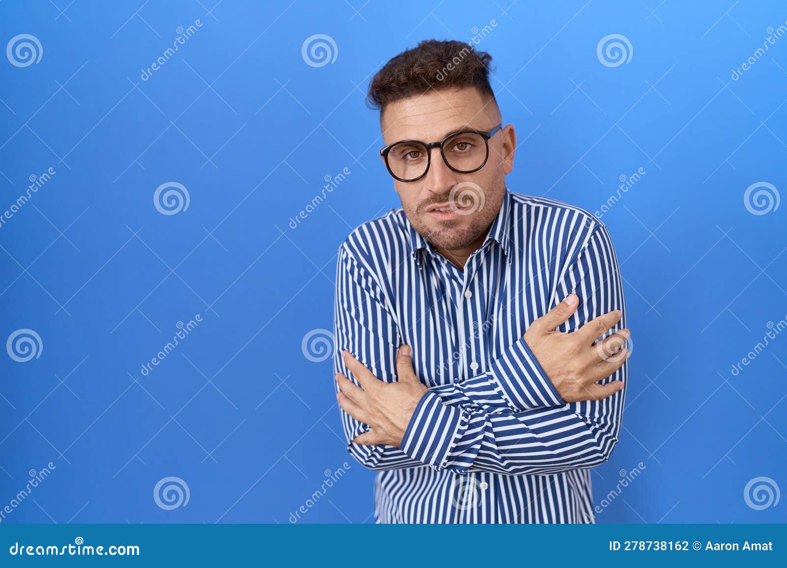 Hispanic Man with Beard Wearing Glasses Shaking and Freezing for Winter ...