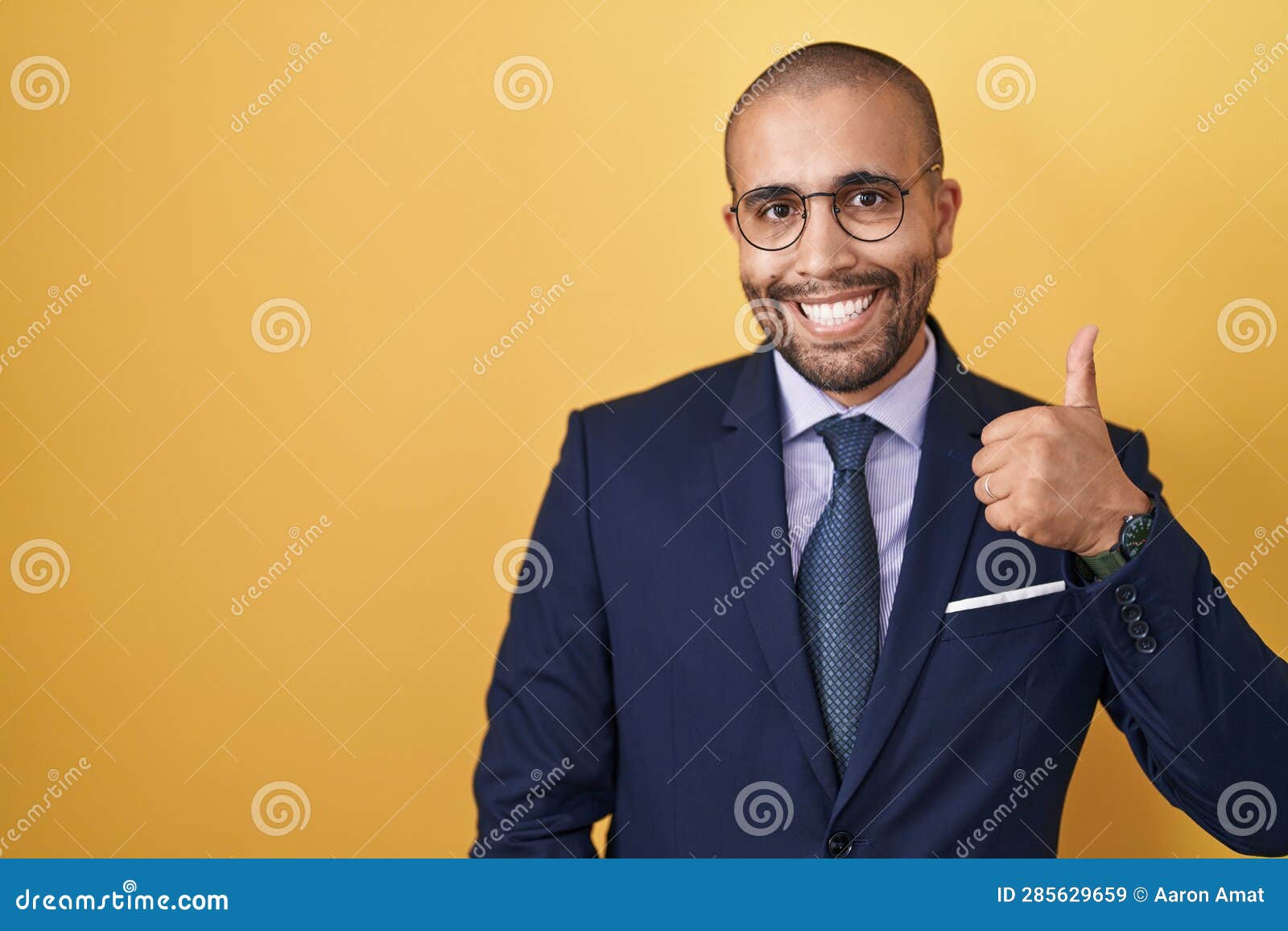 Hispanic Man With Beard Wearing Suit And Tie Doing Happy Thumbs Up