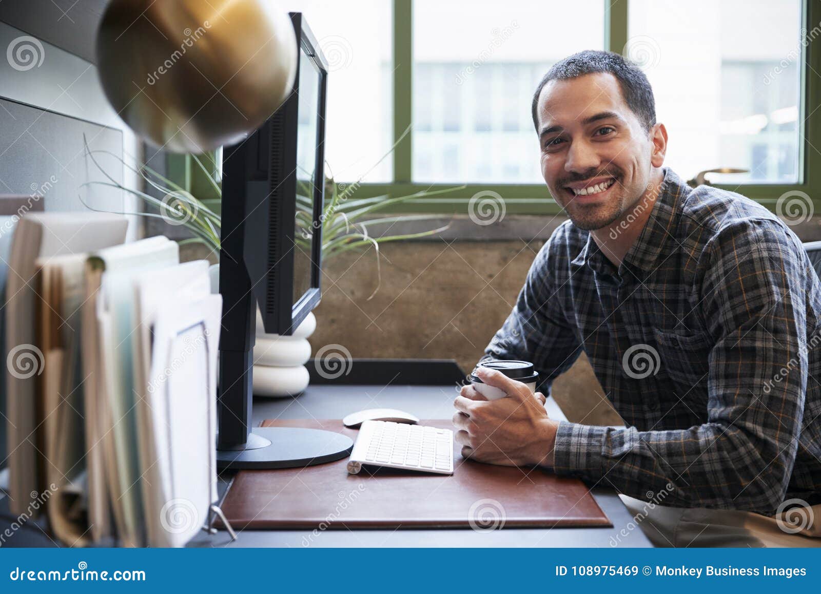 Hispanic Man at a Computer in an Office Smiling To Camera Stock Image ...