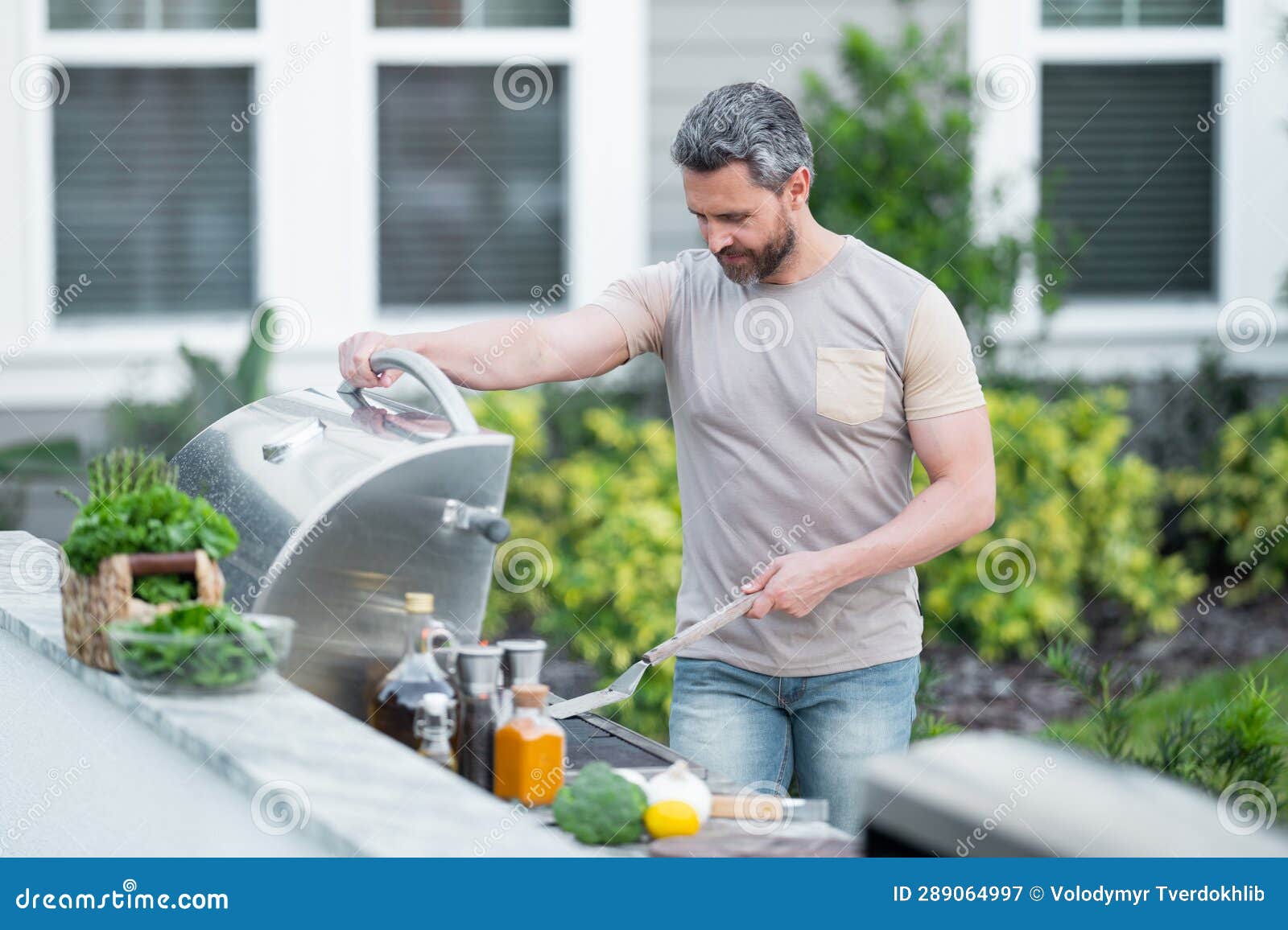 Hispanic Man Cooking on Barbecue in the Backyard. Chef Preparing ...