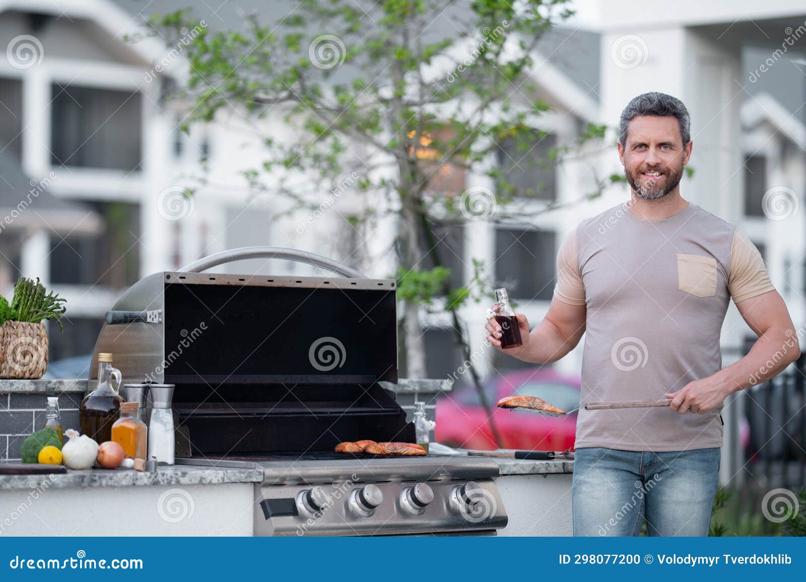 Hispanic Man Cooking on Barbecue in the Backyard. Chef Preparing ...