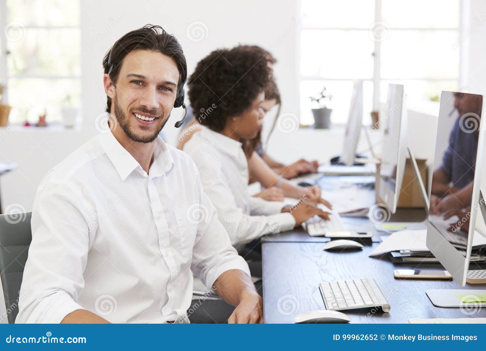 Hispanic Man with Headset on Smiling To Camera in an Office Stock Photo ...