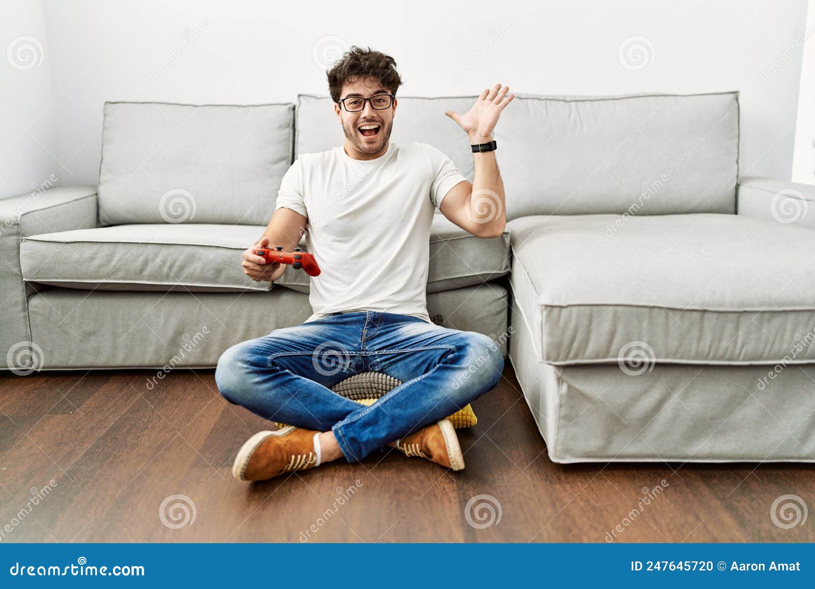 Hispanic Man Playing Video Game Holding Controller by the Sofa ...