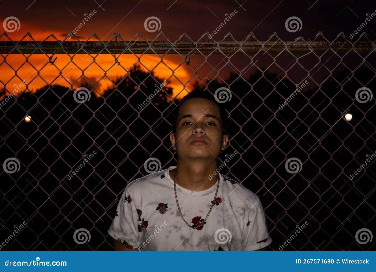 Hispanic Man Posing on Cyclone Fence Stock Photo - Image of background ...
