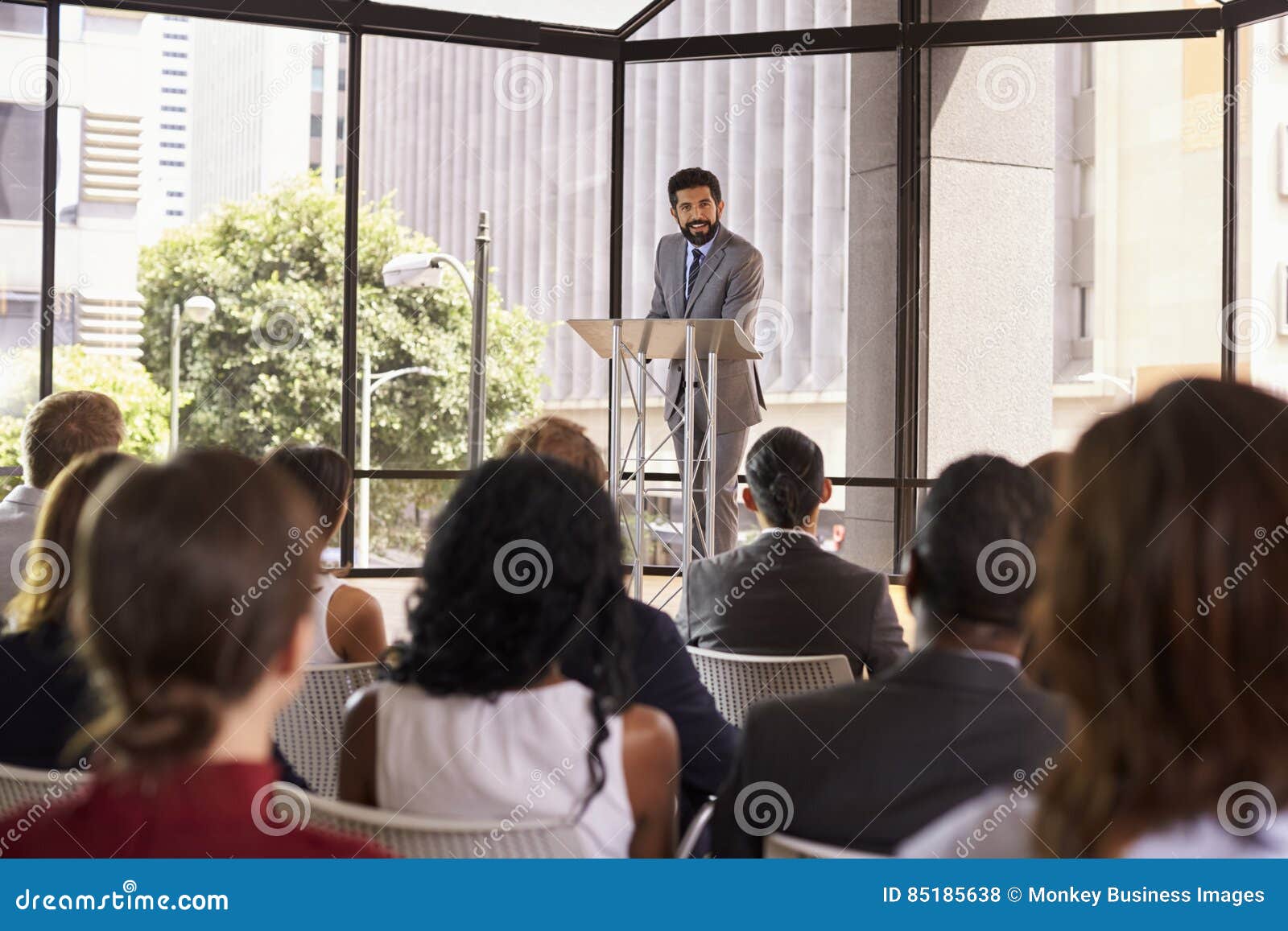 Hispanic Man Presenting Business Seminar Leaning on Lectern Stock Photo ...