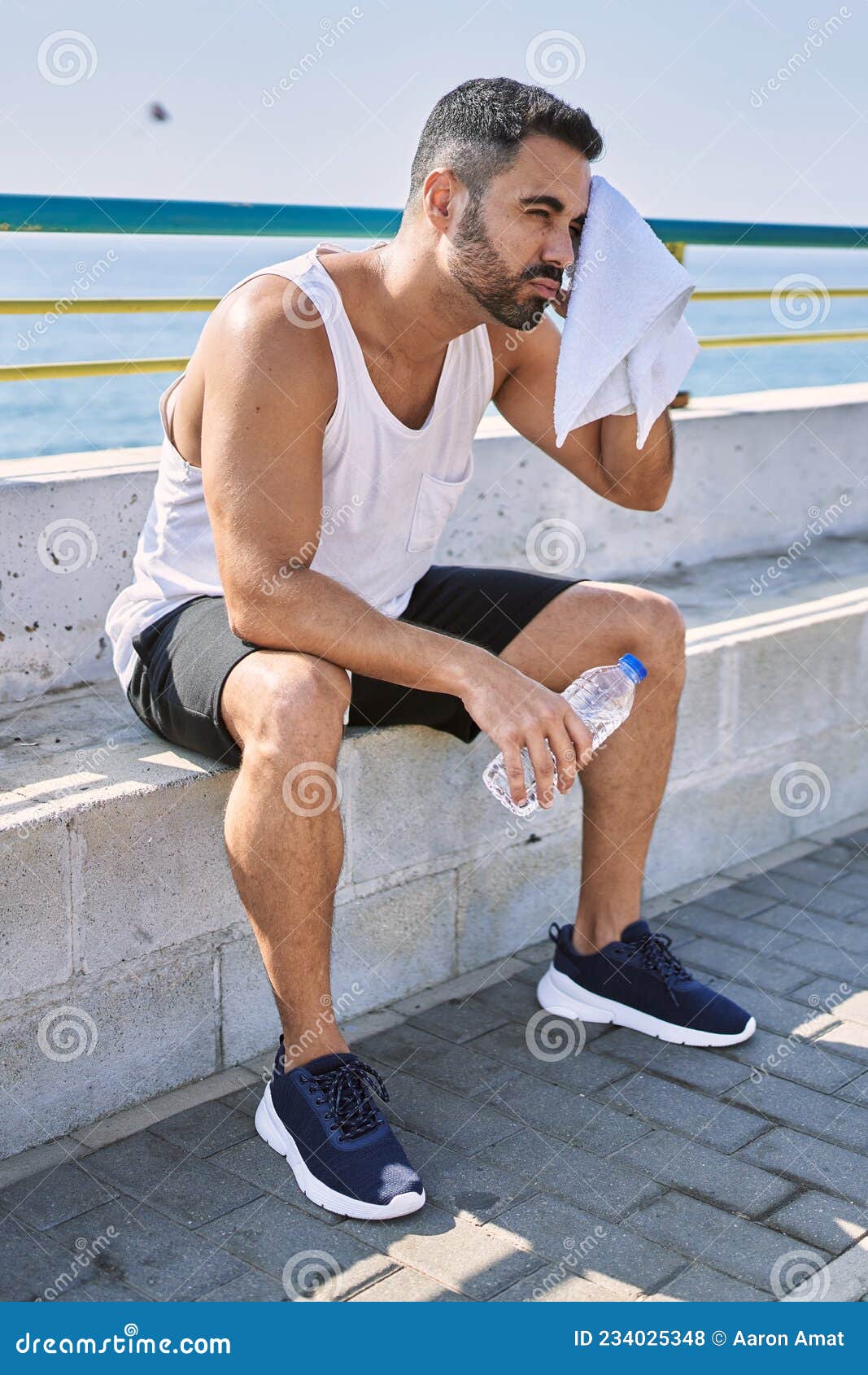 Hispanic Man Resting Sitting on a Bench after Working Out Outdoors on a ...