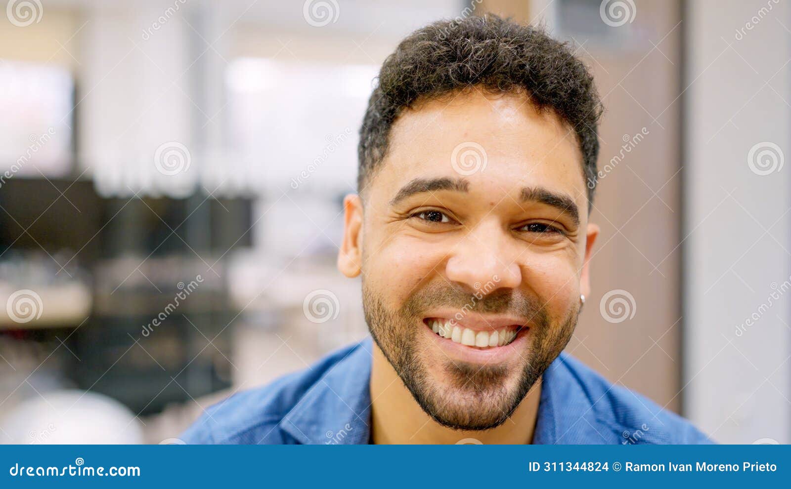 Hispanic Man Smiling at Camera Working in a Coworking Stock Photo ...